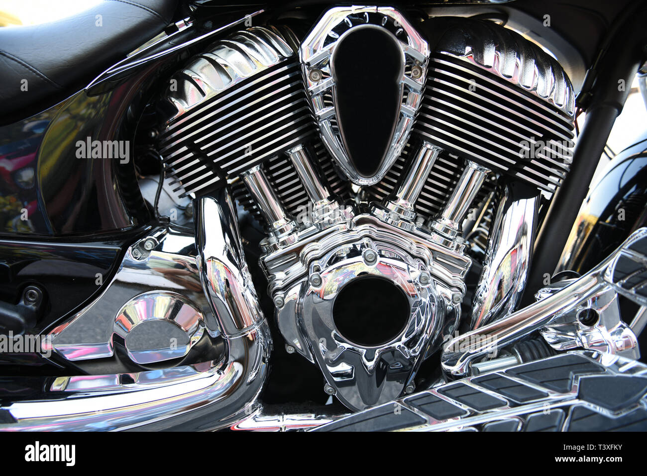 Full frame close up profile of a shiny chrome motorcycle engine ...