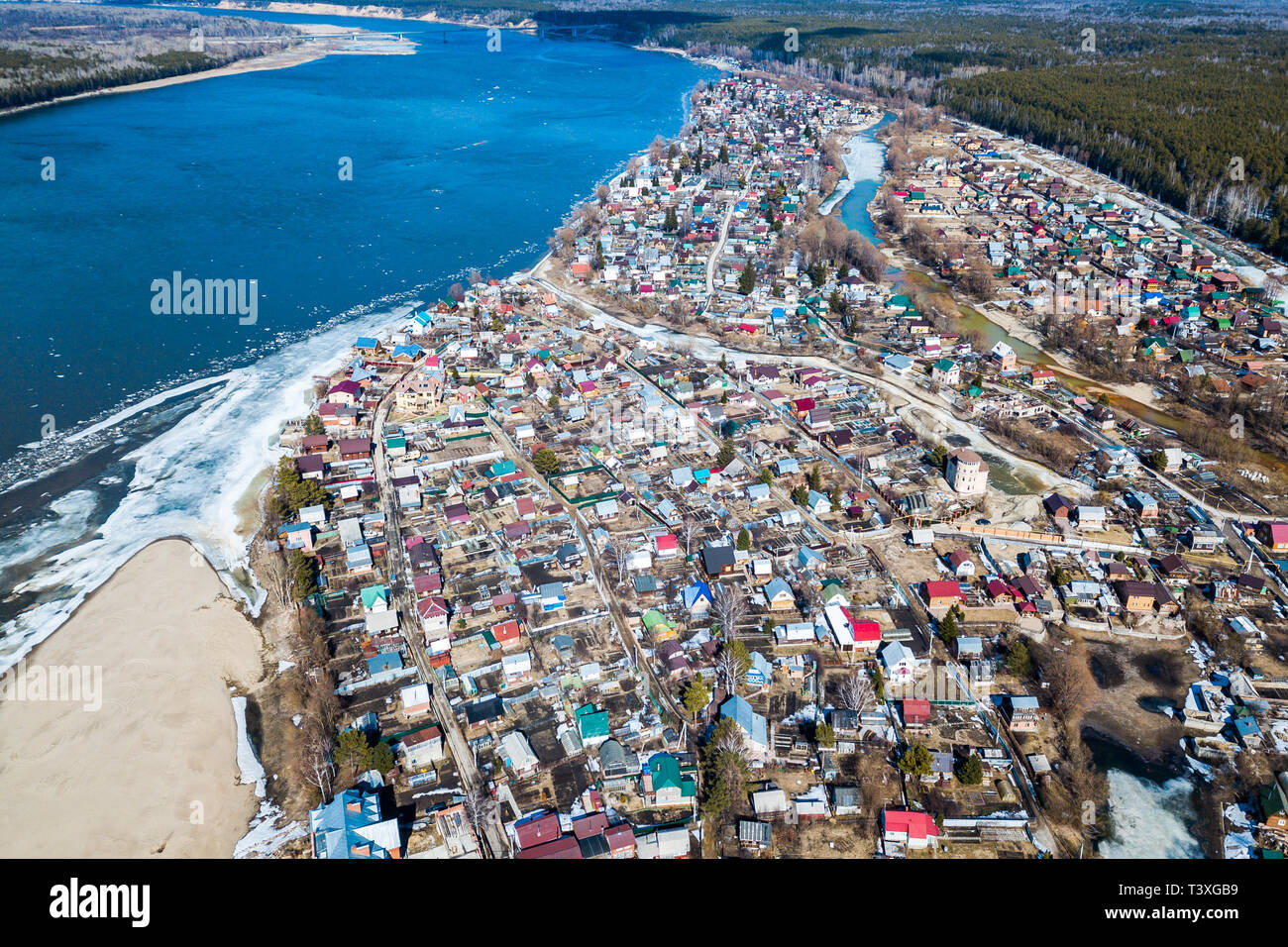 Aerial photography of a small village with villas and cottages, river ...