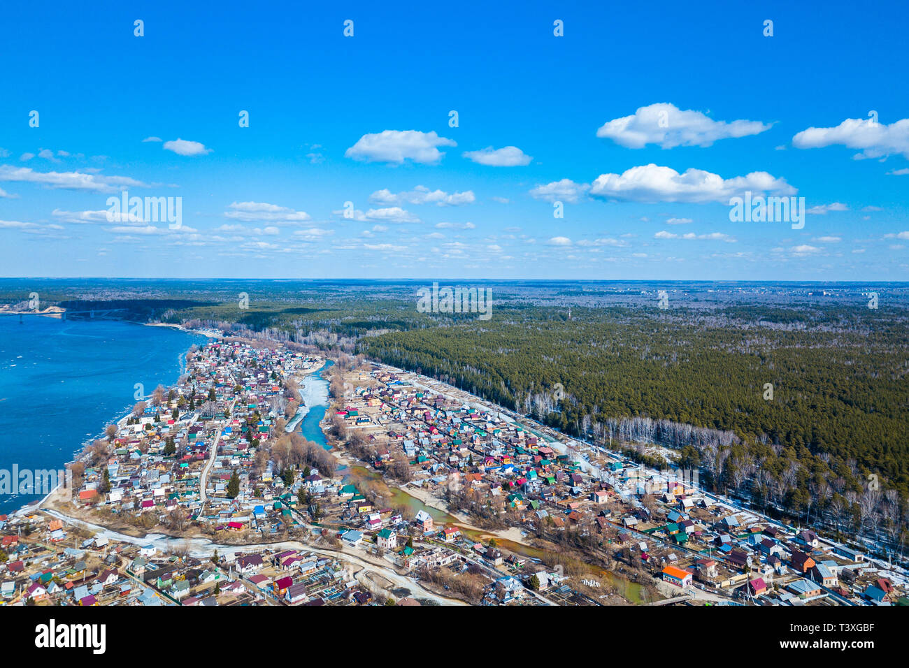 Aerial photography of a small village with villas and cottages, river ...