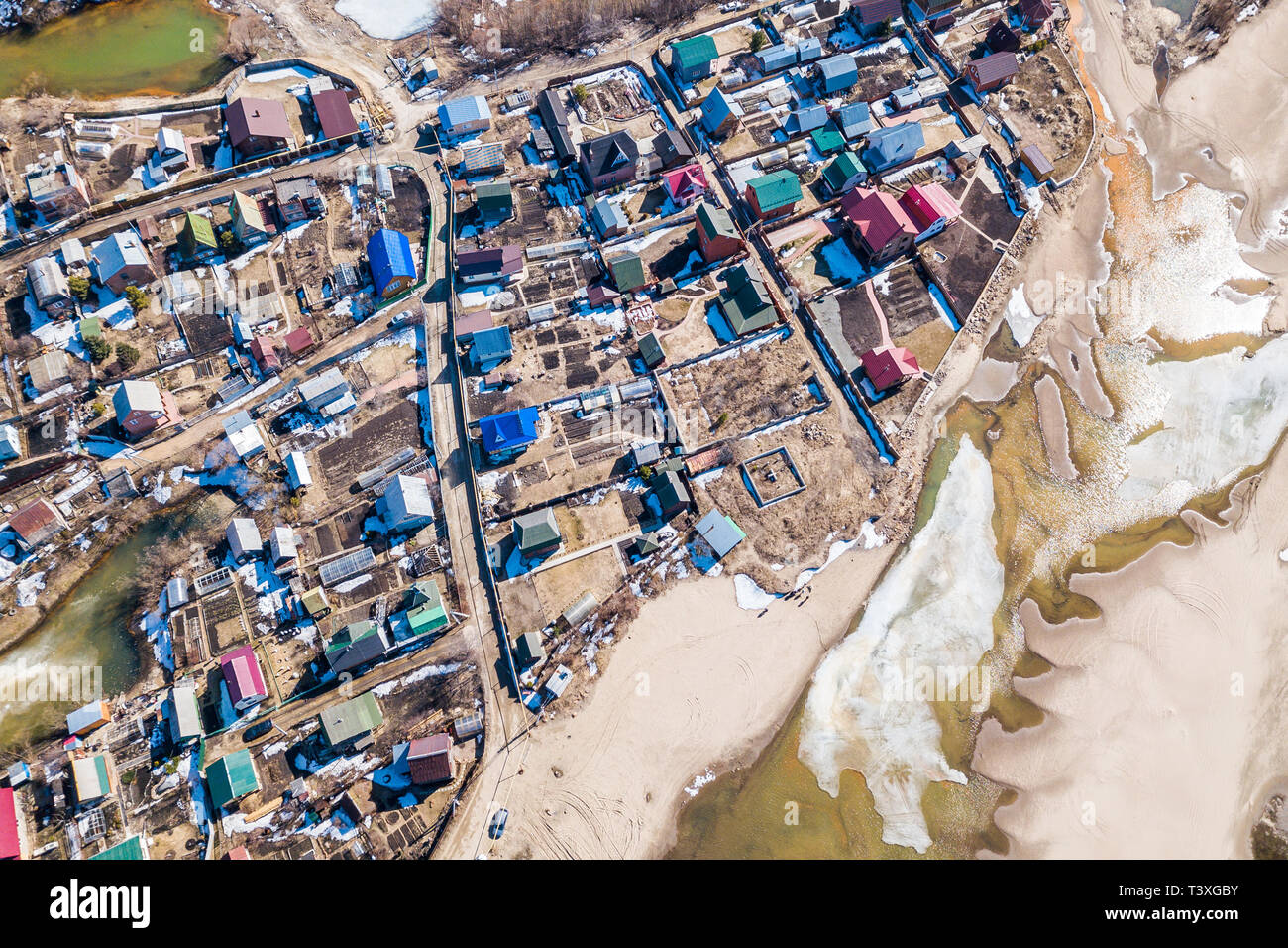 Aerial photography of a small village with villas and cottages, river ...