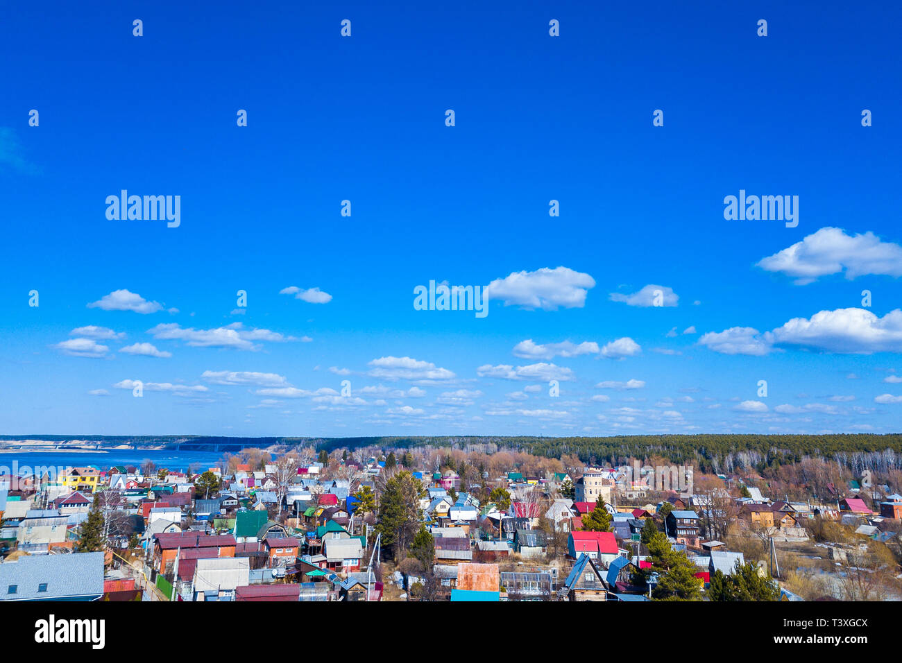 Aerial photography of a small village with villas and cottages, river ...