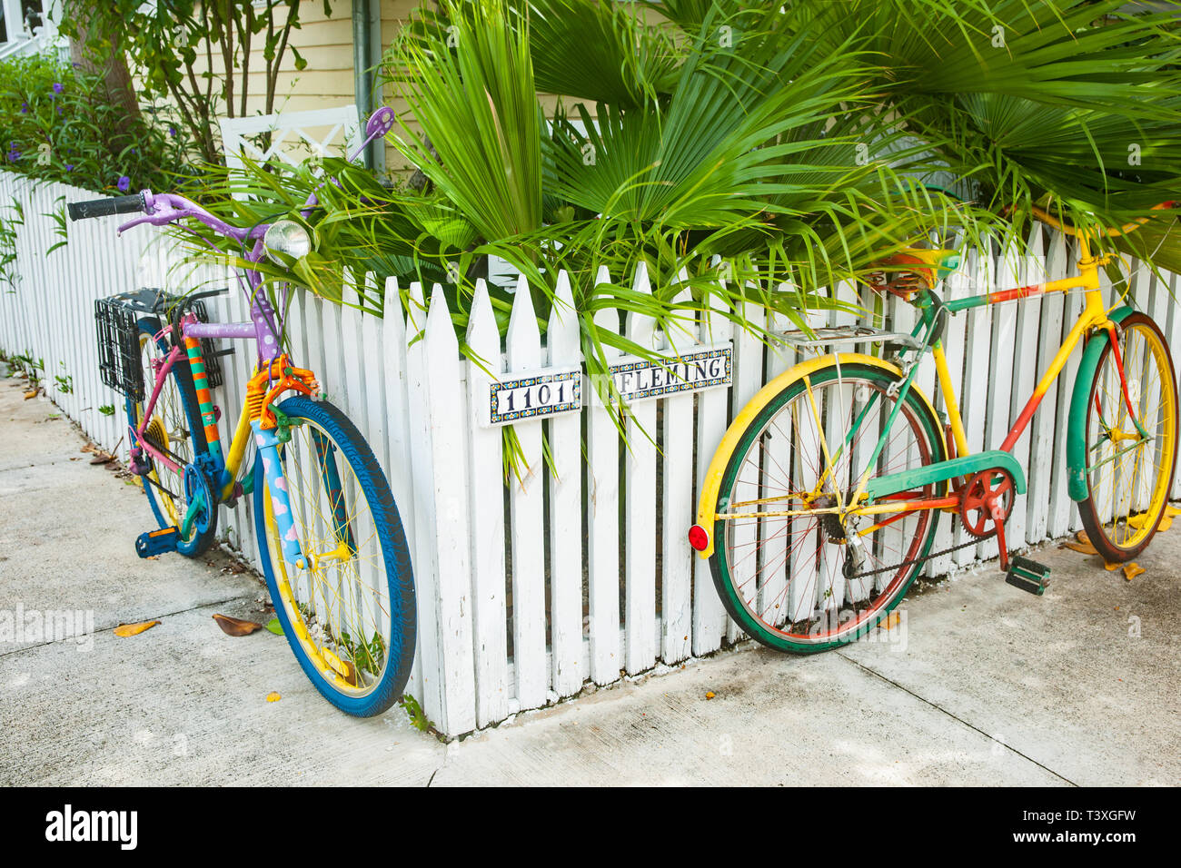 KEY WEST USA - JUNE 26 2012;Two multi-colored cycles attached to white ...