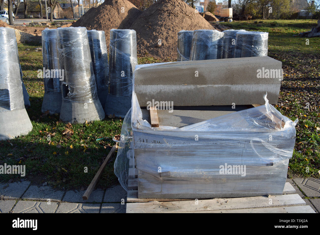 New concrete street light lamp base group and pavement edging stack ...