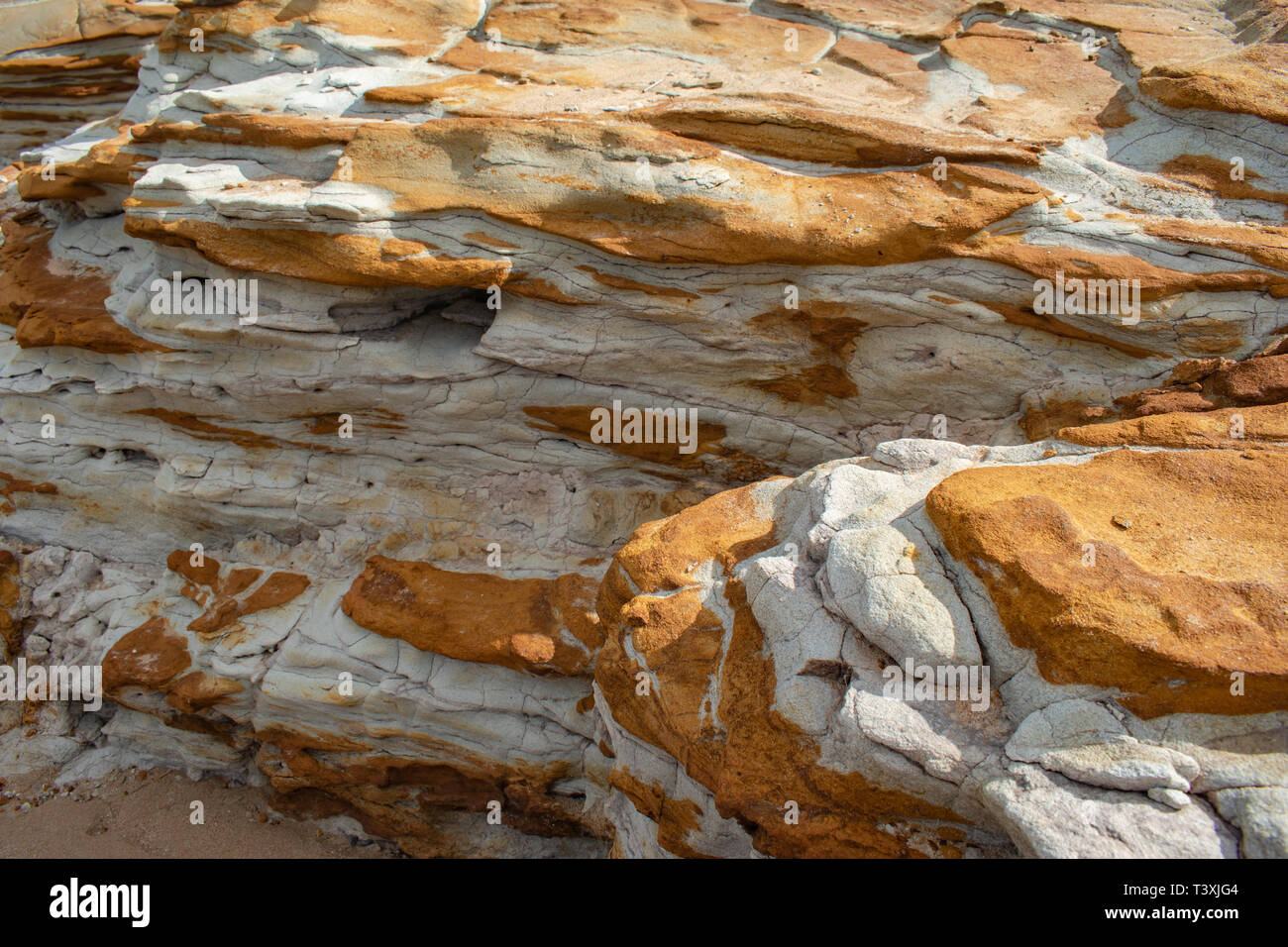 A limestone rock outcrop with different bands of rock, color and ...