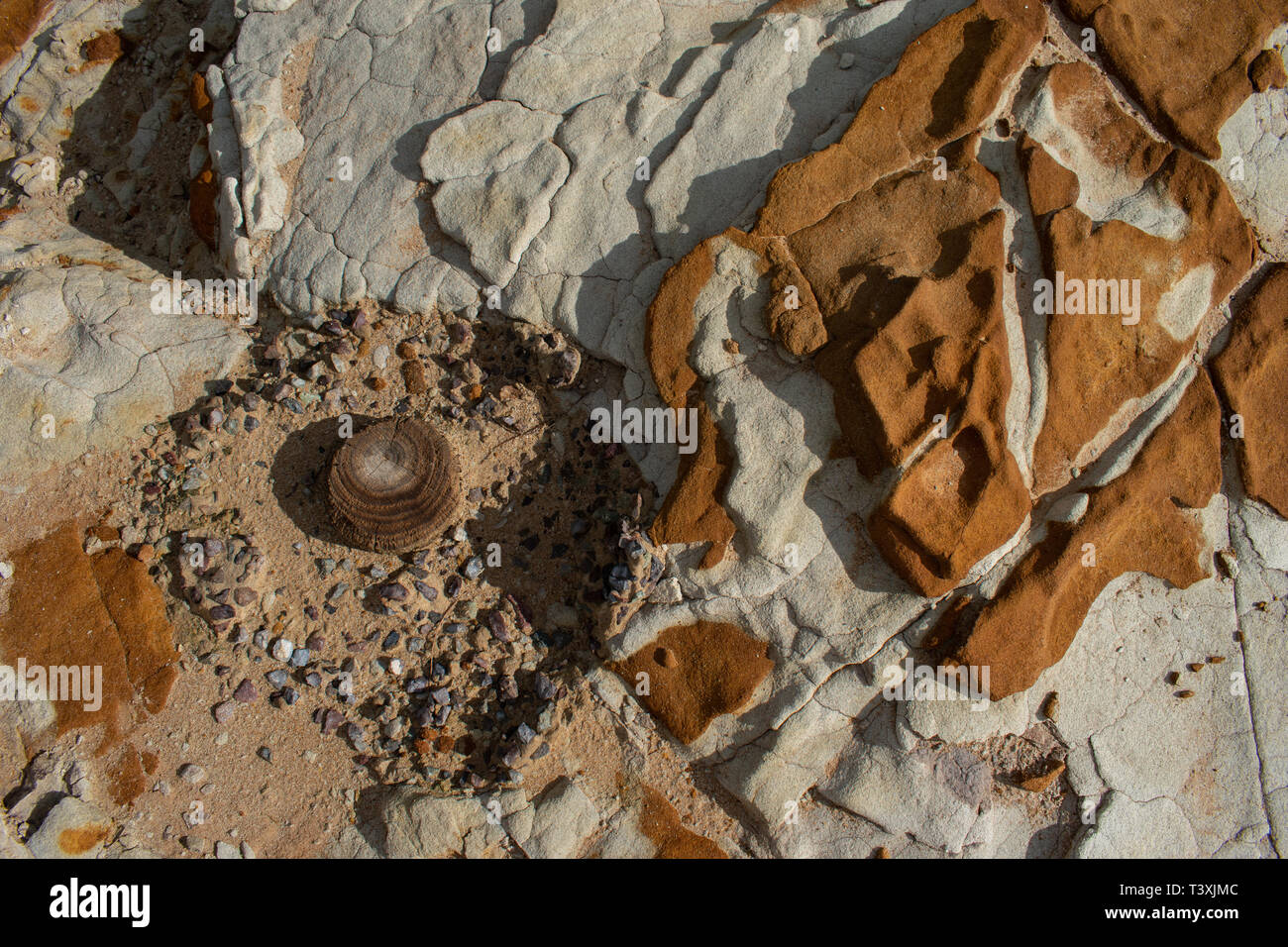 A cut off gate post and limestone rock outcrop with different bands of ...