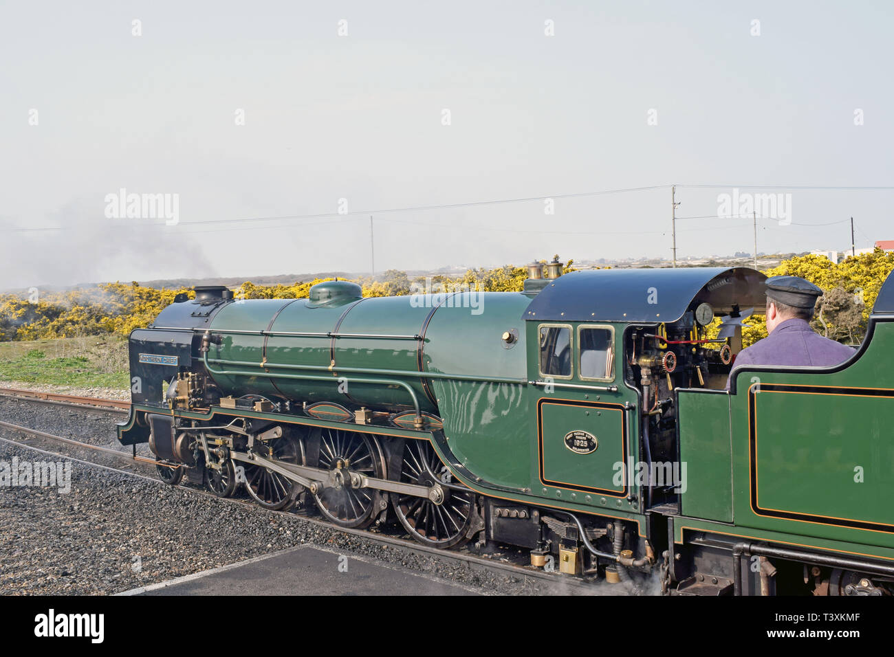 The green steam Locomotive's engine as it leaves the station in ...