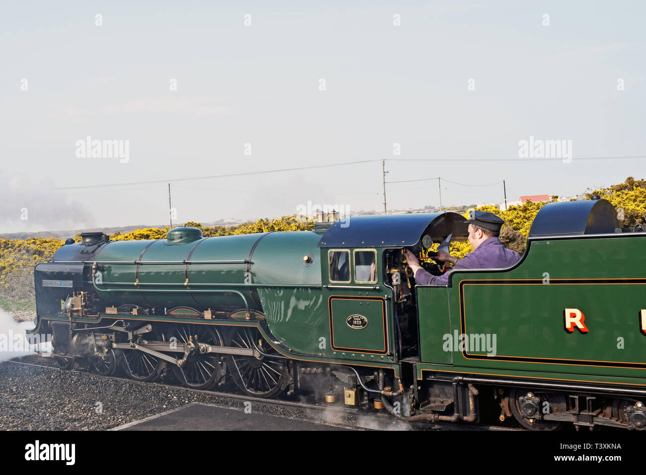 The green steam Locomotive's engine as it leaves the station in ...