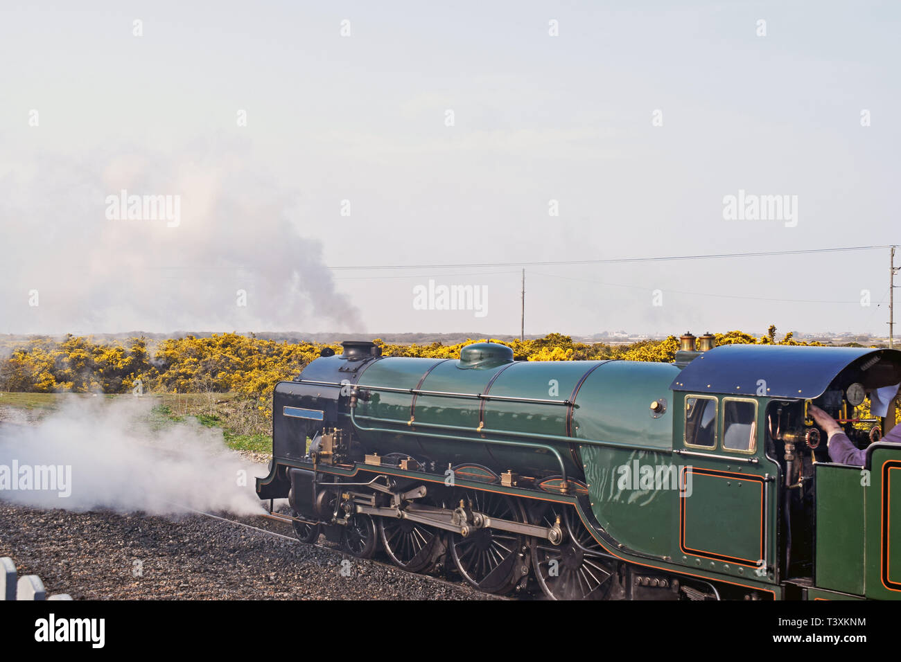 The green steam Locomotive's engine as it leaves the station in ...