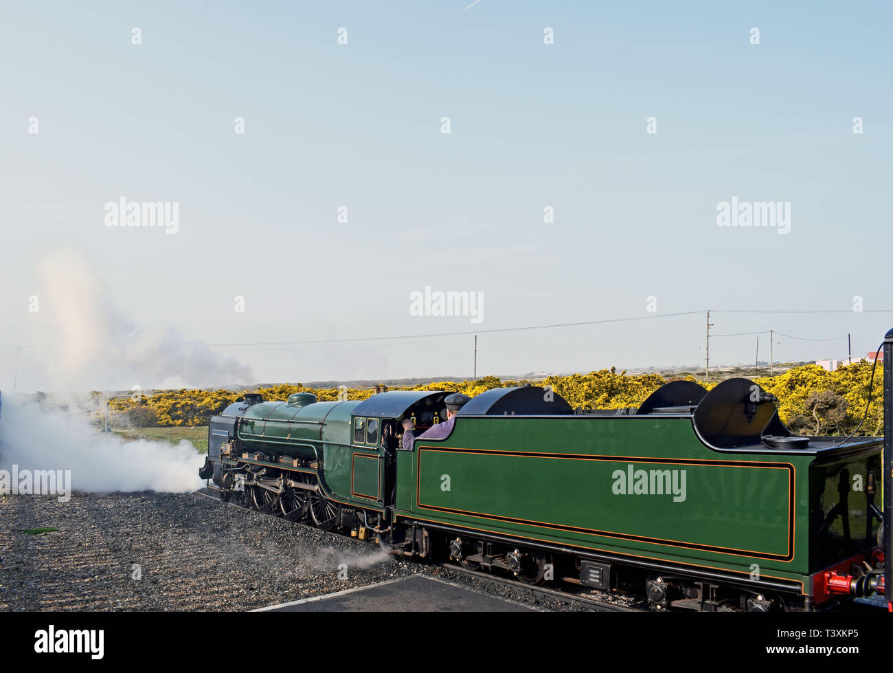 The green steam Locomotive's engine as it leaves the station in ...