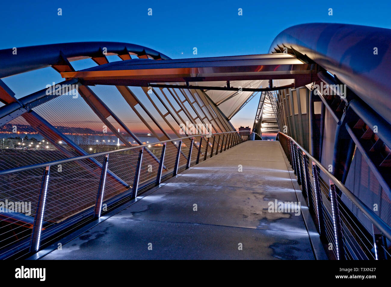 Illuminated footbridge over Seattle cityscape at night, Washington ...