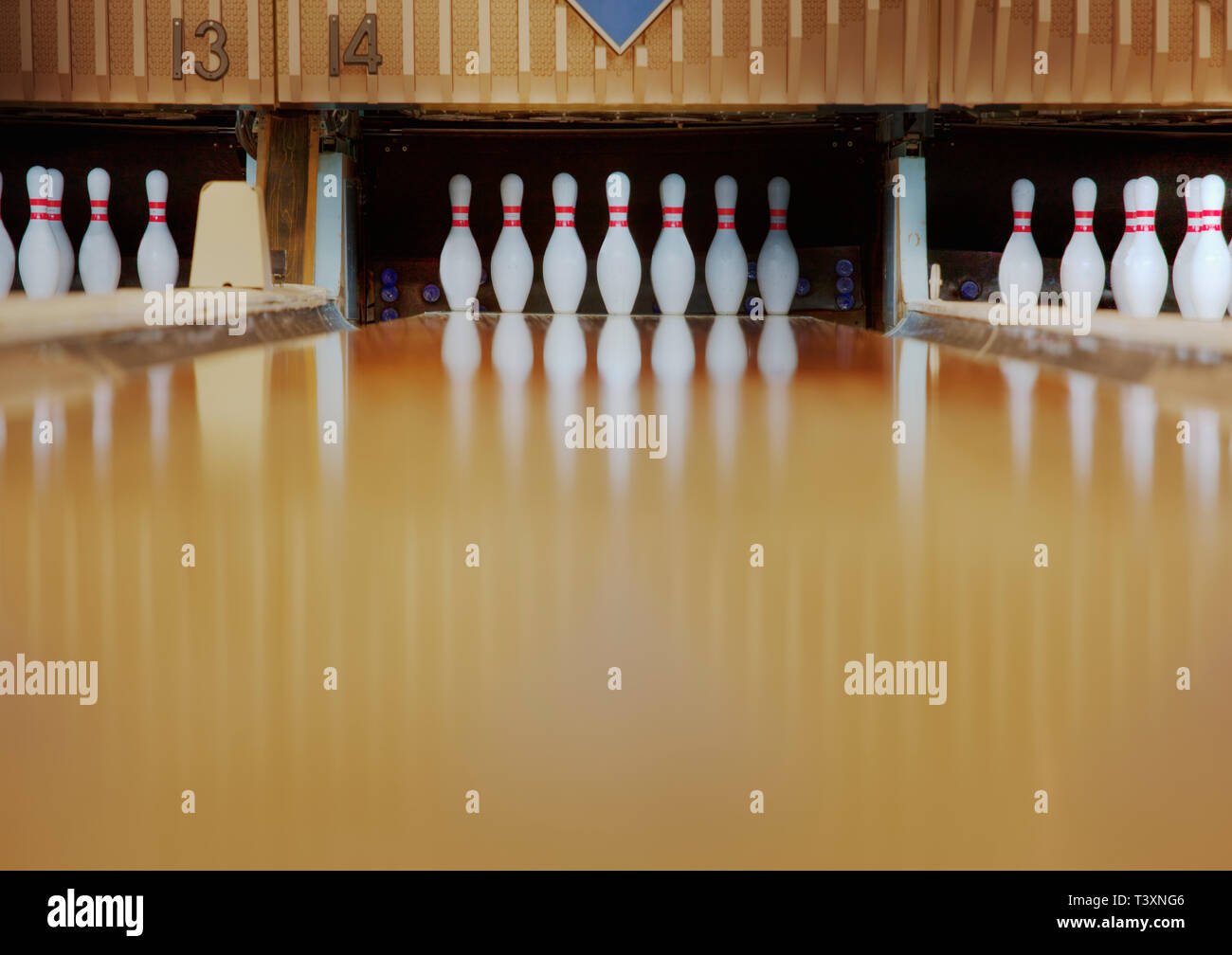 Bowling pins reflecting in bowling alley lane Stock Photo - Alamy