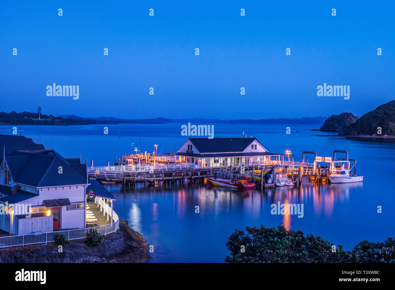 Illuminated building on water at dawn Stock Photo - Alamy