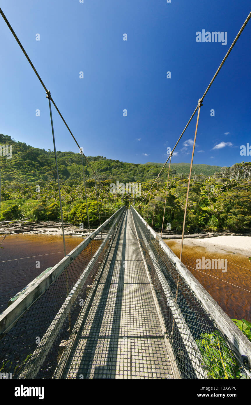 Suspension bridge over tropical beach Stock Photo - Alamy