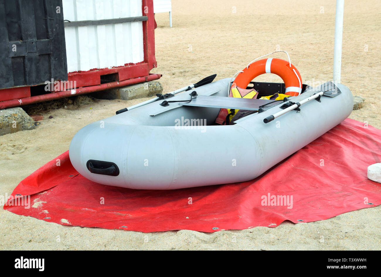 Inflatable Rescue Boat. Gray inflatable boat on the beach in the sand ...