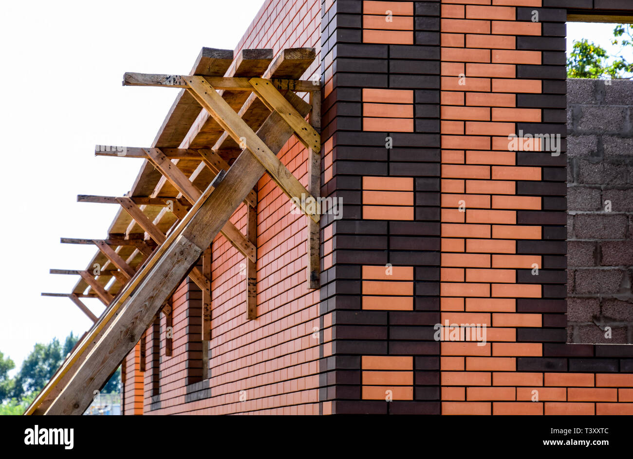 New brick house under construction. Brown and pink brick Stock Photo ...