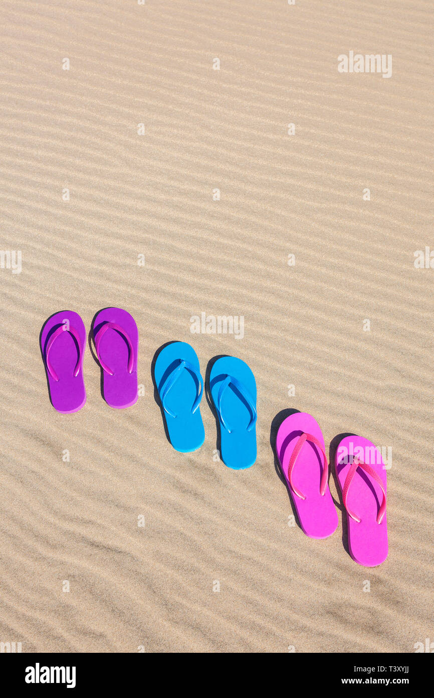 Colorful flip flops on sand Stock Photo - Alamy