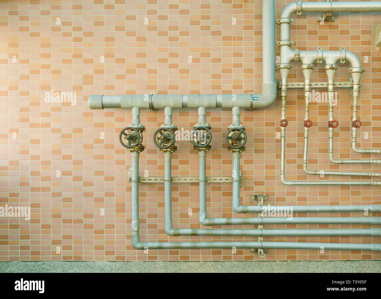 Water pipes on brick wall Stock Photo - Alamy