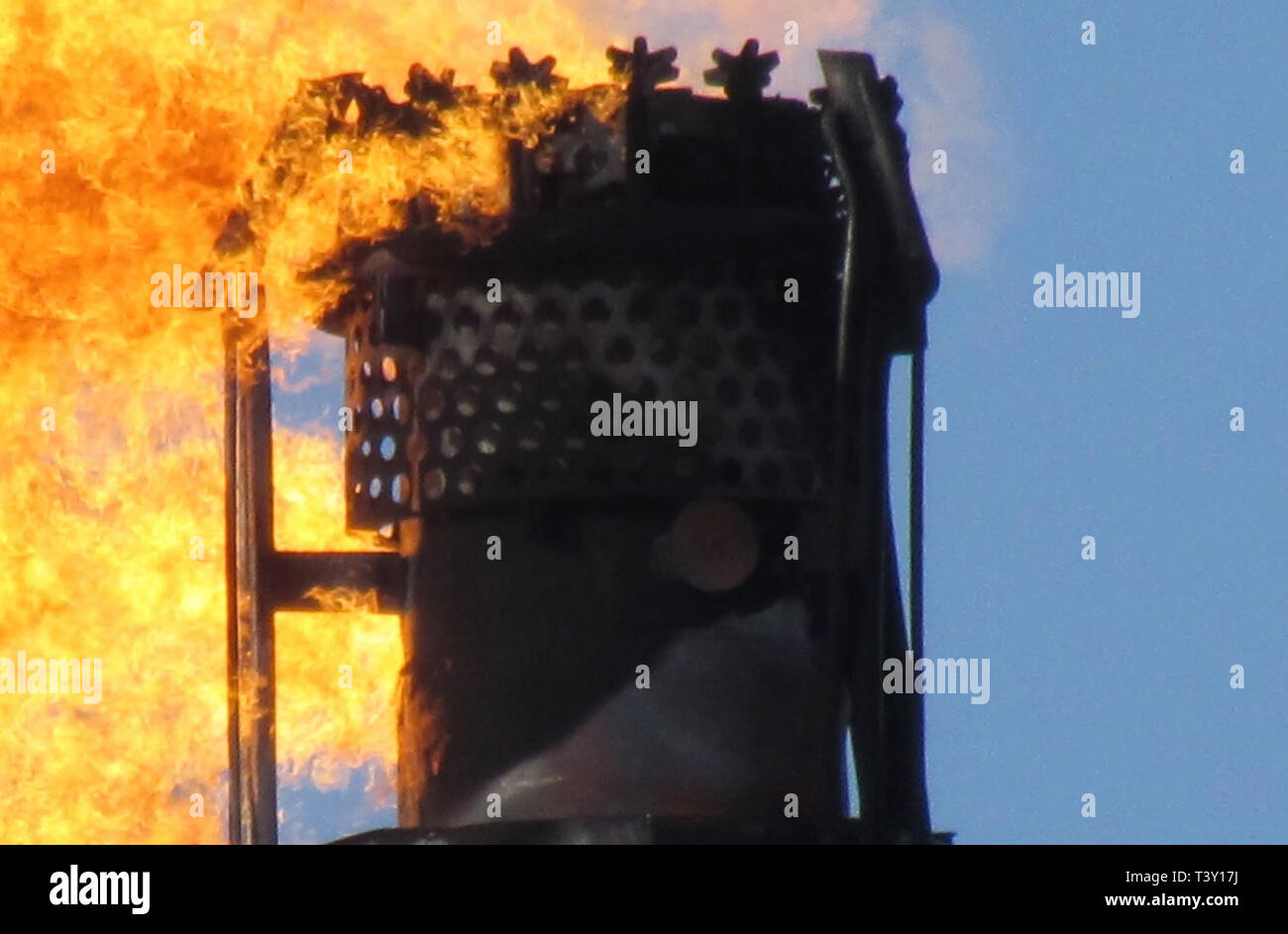 System of a torch on an oil field. Burning through a torch head Stock ...