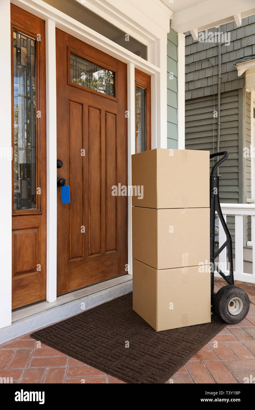 Cardboard boxes on front porch of house Stock Photo - Alamy