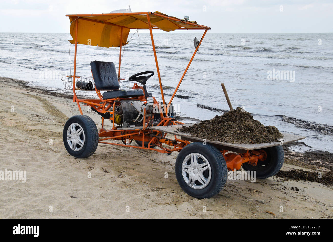 The car for garbage collection from the beach. Cleaning on the beach ...