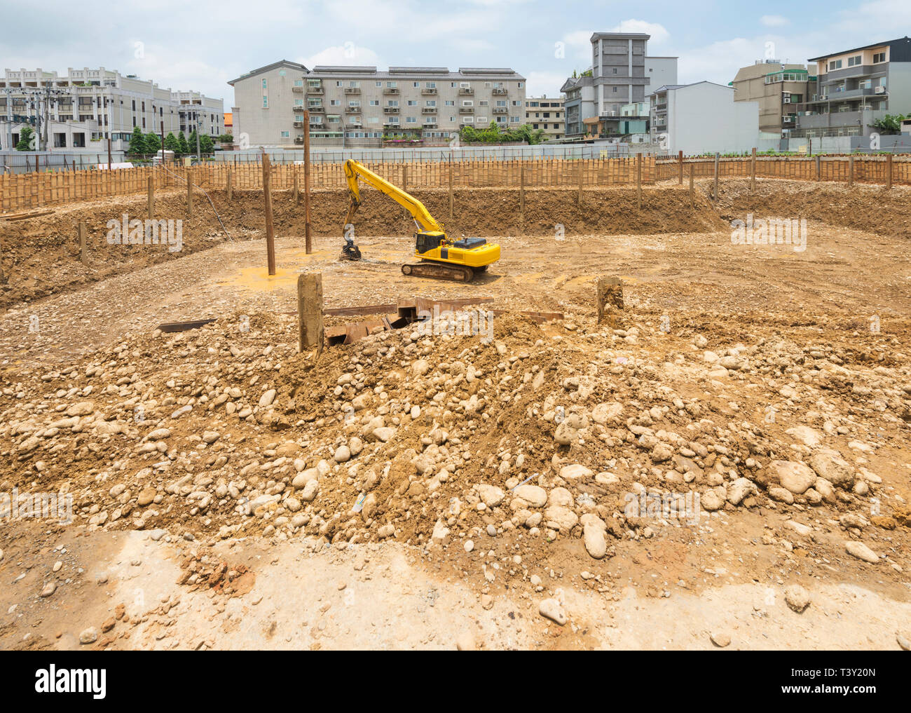 Digger working on construction site Stock Photo - Alamy