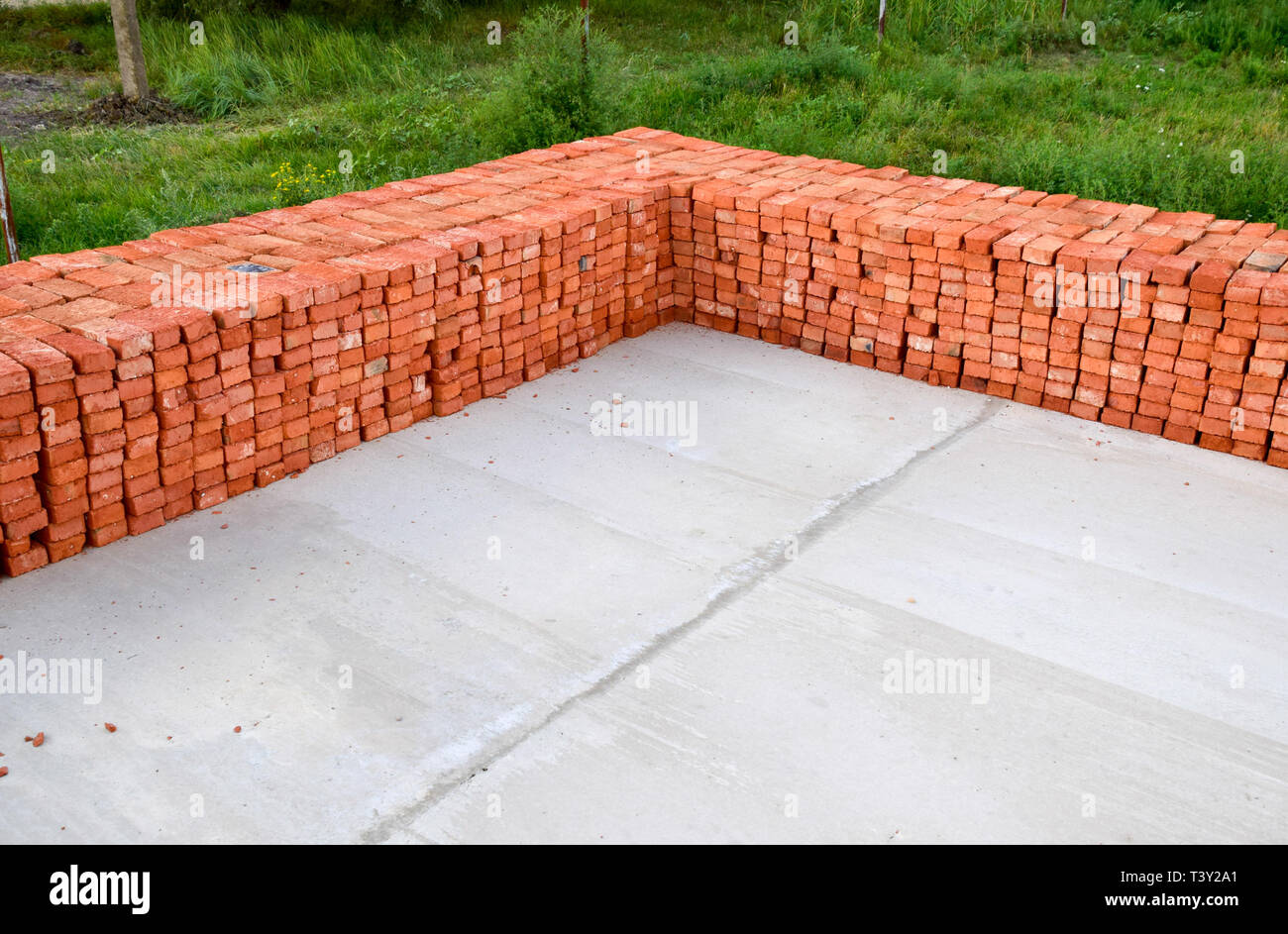 The red brick folded neatly on the foundation of the house. Home ...