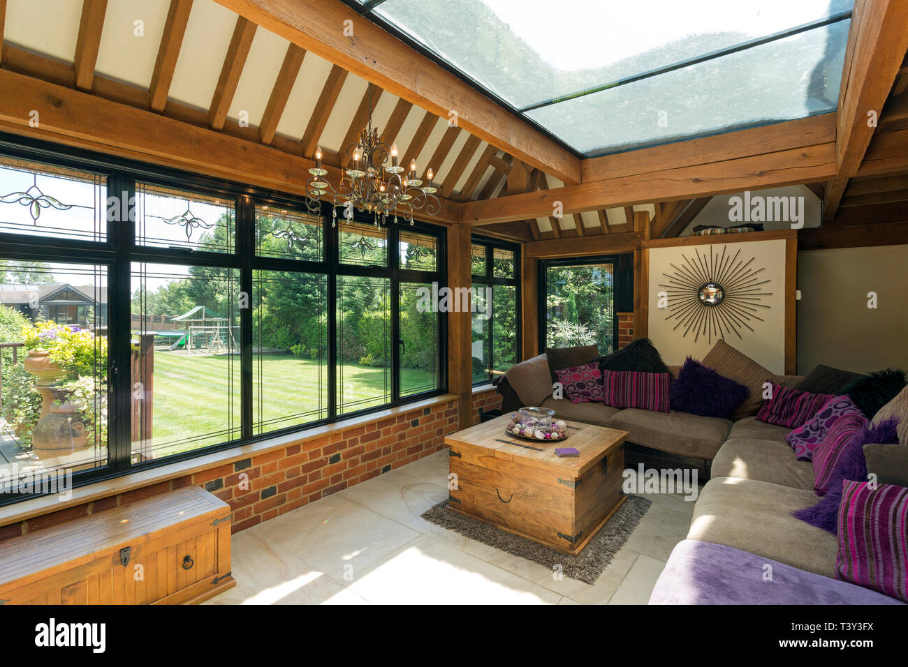 Cushioned benches in sunny conservatory Stock Photo - Alamy