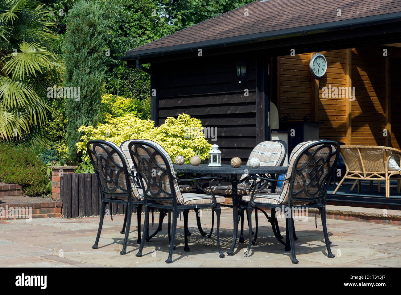 Table and chairs on back porch Stock Photo - Alamy