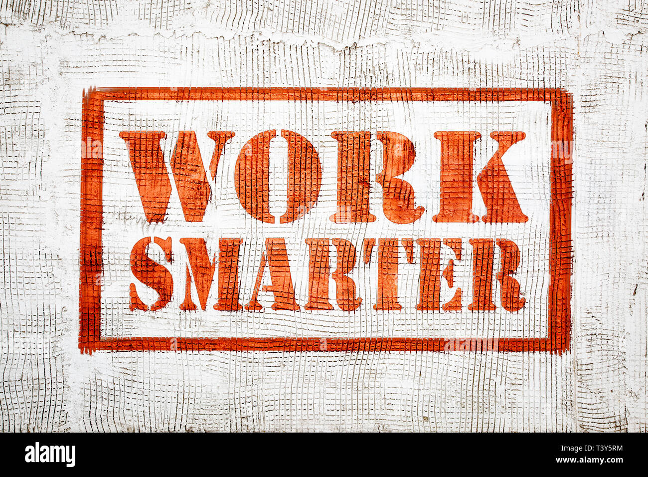 work smarter - red graffiti style sign on a white stucco wall Stock ...