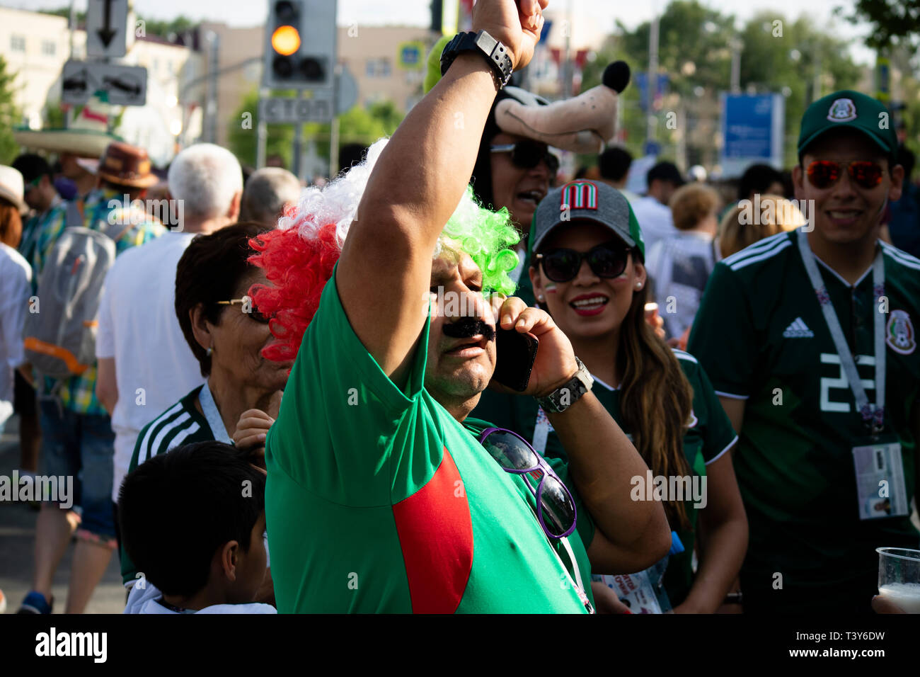 Male Mexican football fan with moustache making phone call while waving ...