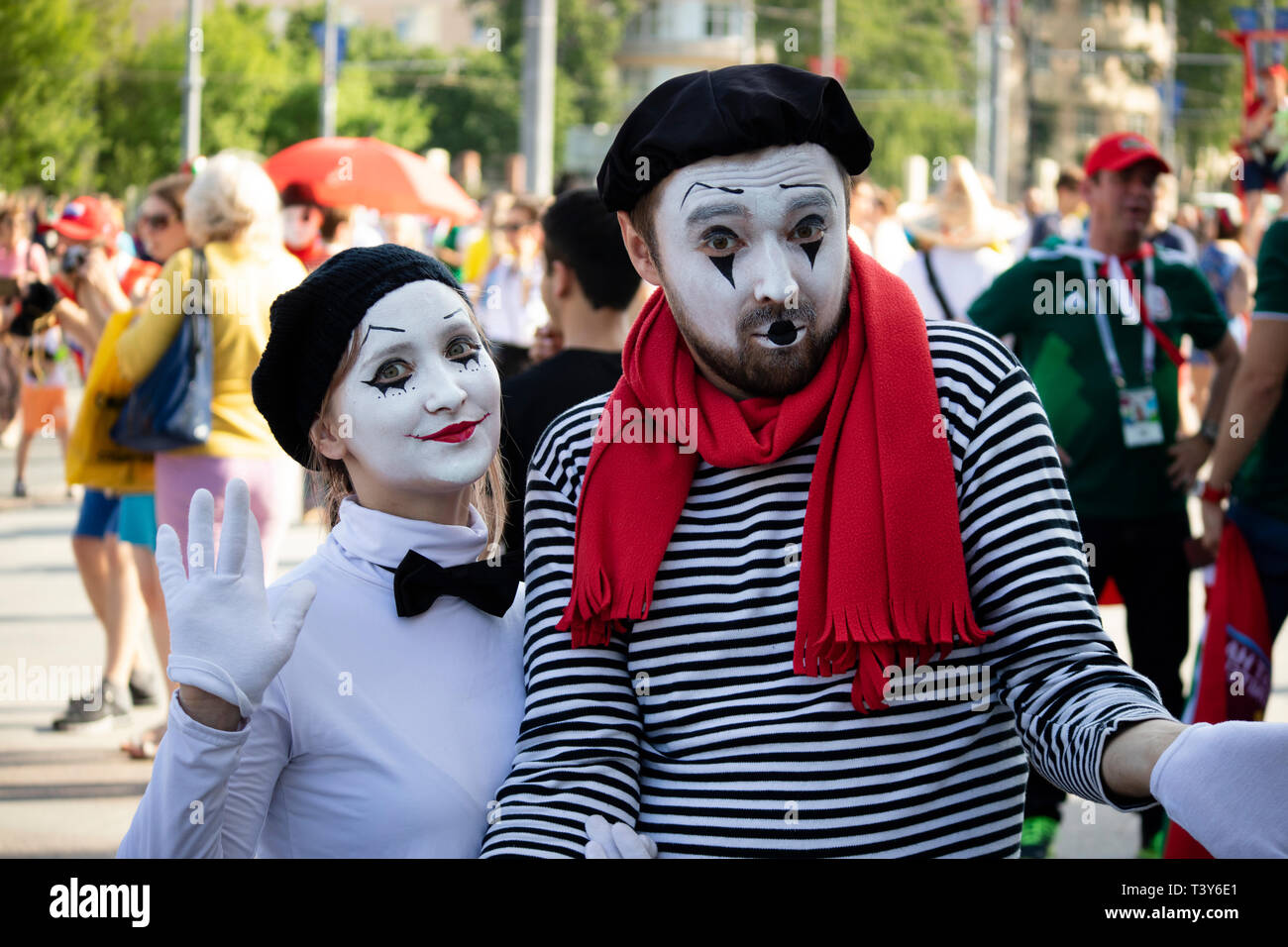Male and female French football fans in mime outfits posing for camera ...