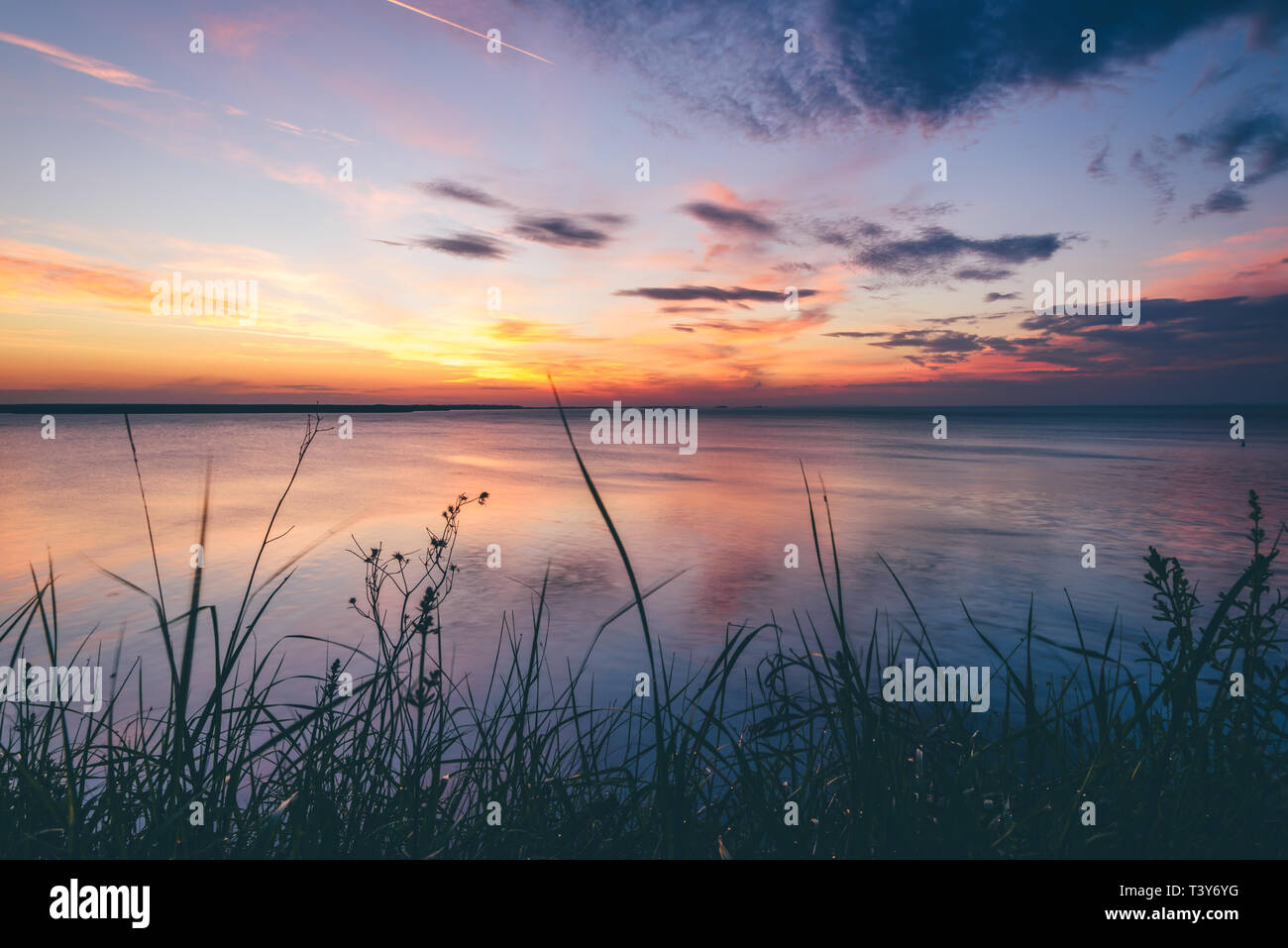 Sunrise on Volga river with reflected sky Stock Photo - Alamy