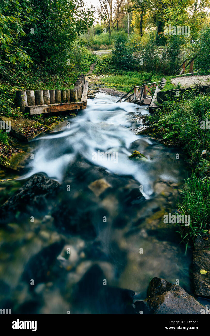 Small forest river flowing through rocks and boulders Stock Photo - Alamy