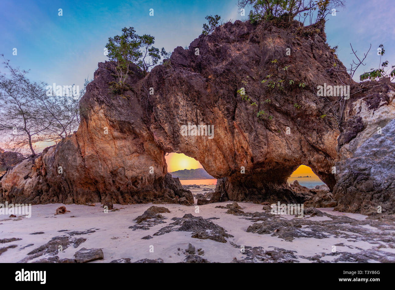 beautiful sunset in the hole of unusual rock wave eroded into the ...