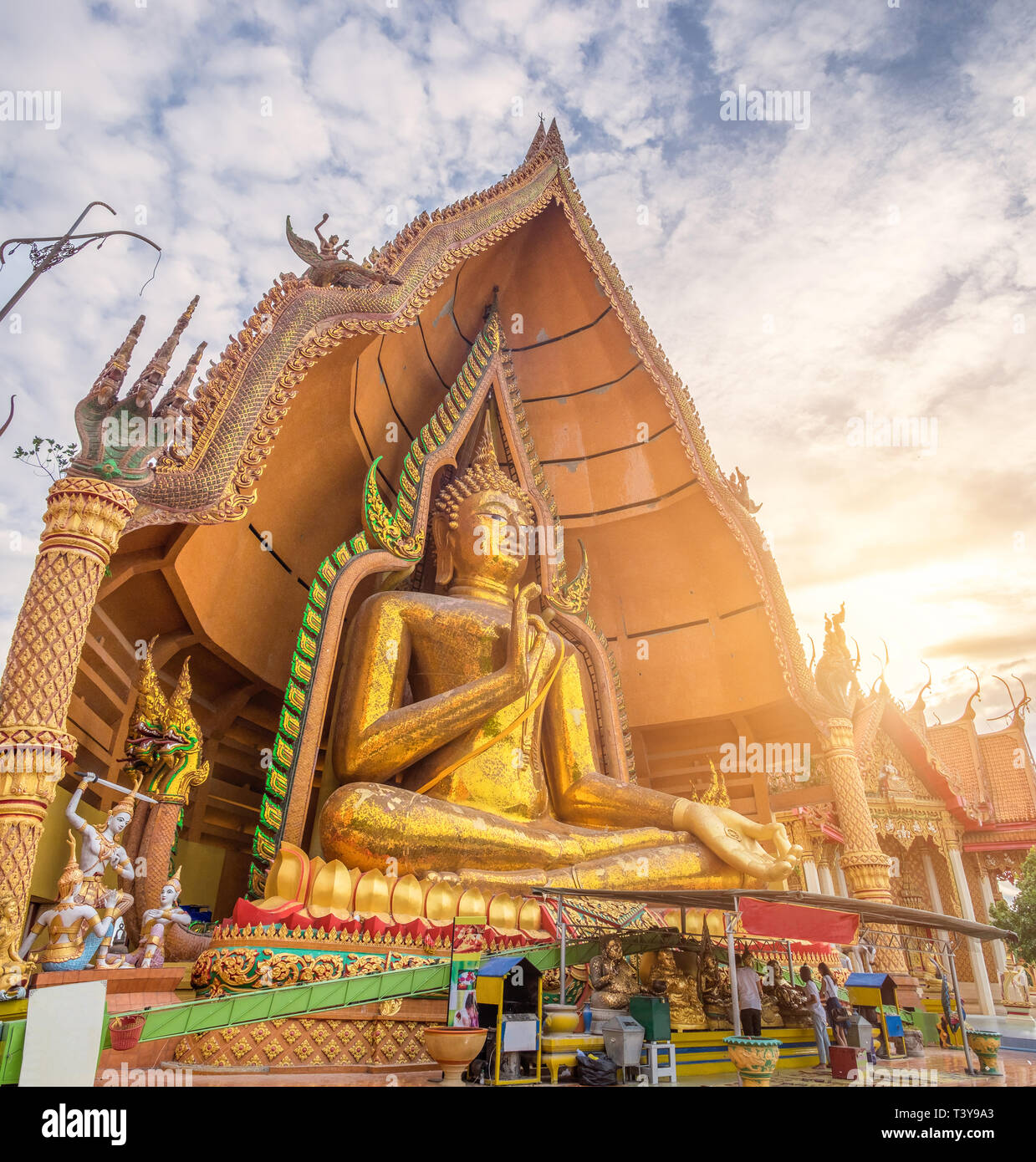 Temple landmark buddha with pagoda golden statue at sunset,wat tham sua ...