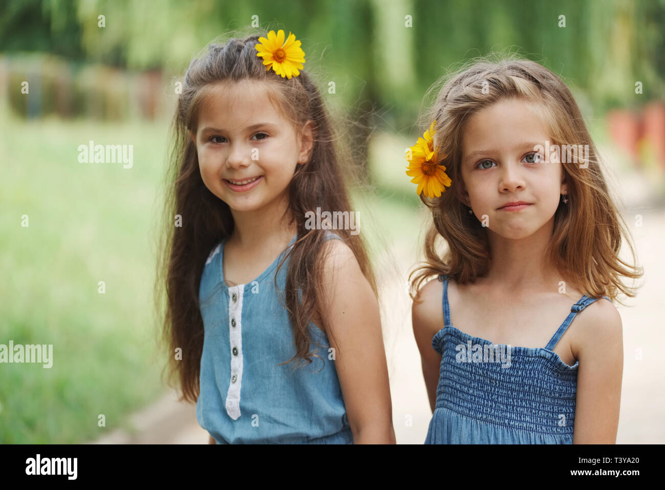 photo of two little girls in summer park Stock Photo - Alamy