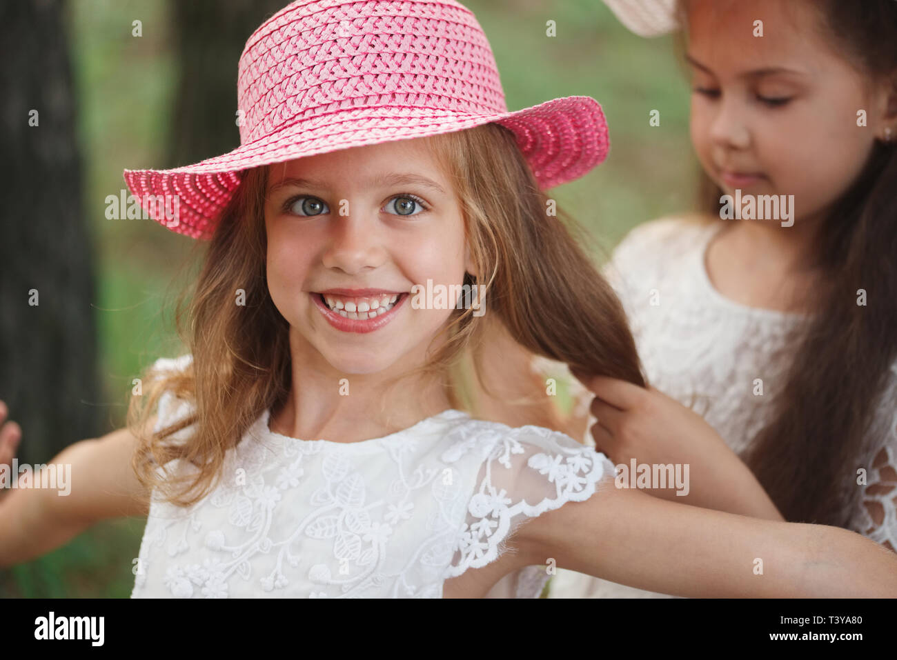 girl braids her friend's braid in park Stock Photo - Alamy