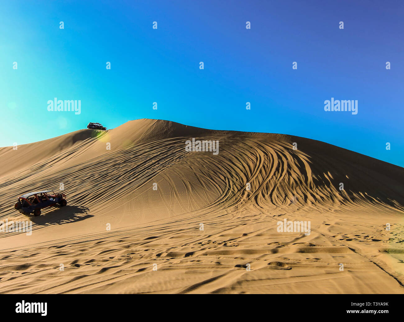 Sand dunes and buggies against clear blue sky at Huacachina, Peru Stock ...