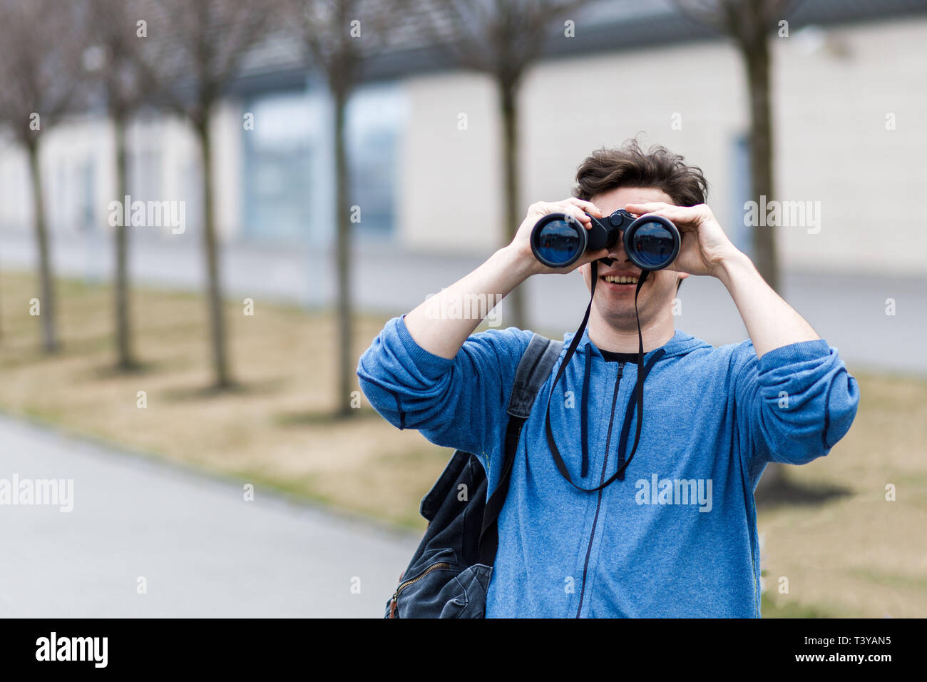 Black man looking through binoculars hi-res stock photography and ...