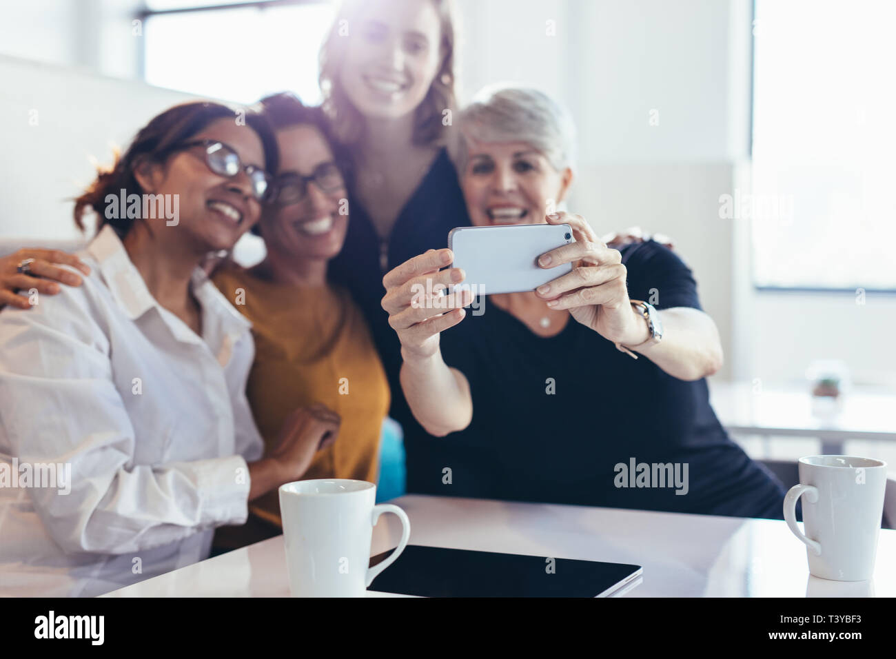 Group of businesswomen taking selfie. Female business professionals ...