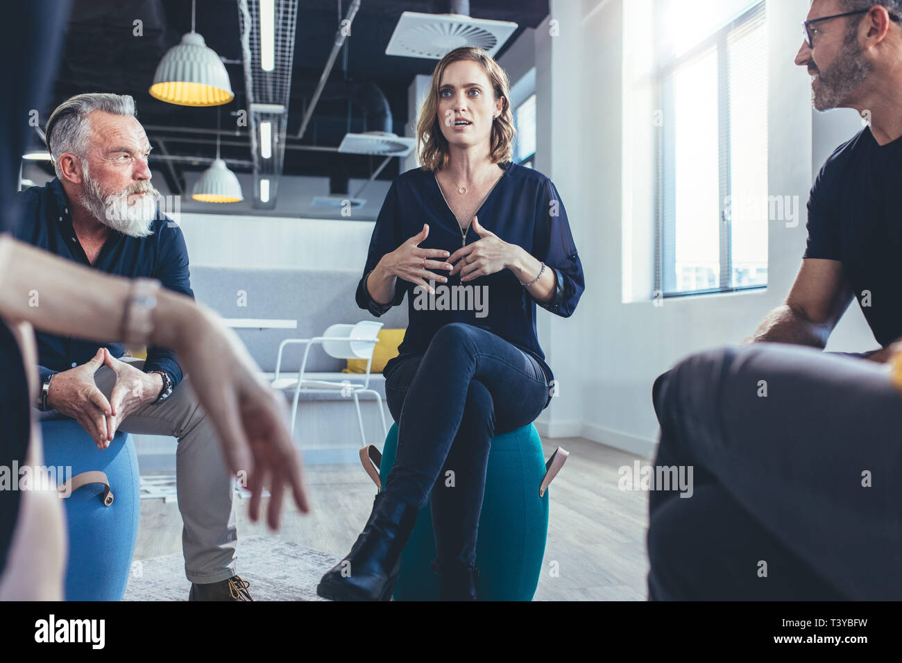 Woman putting forwards her views and suggestions to colleagues during a ...