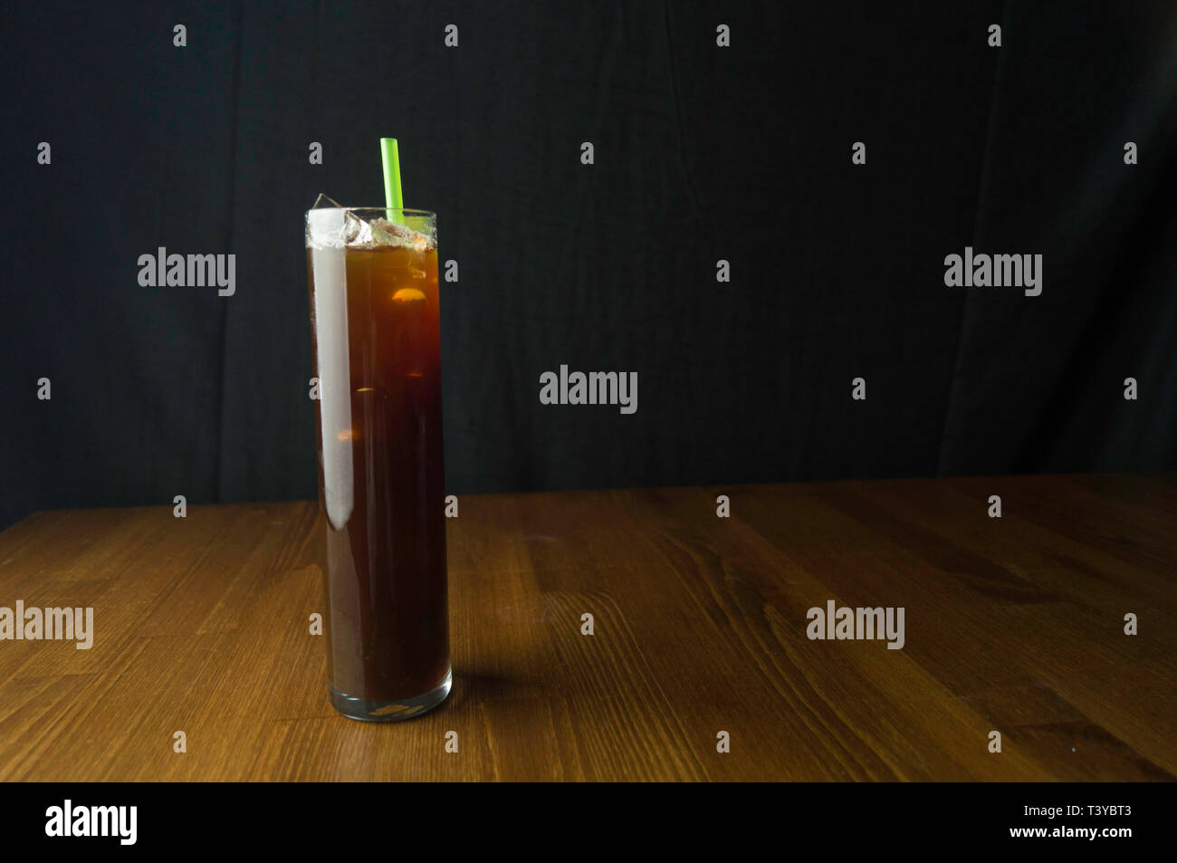 in a long thin glass pipette is iced tea Stock Photo - Alamy