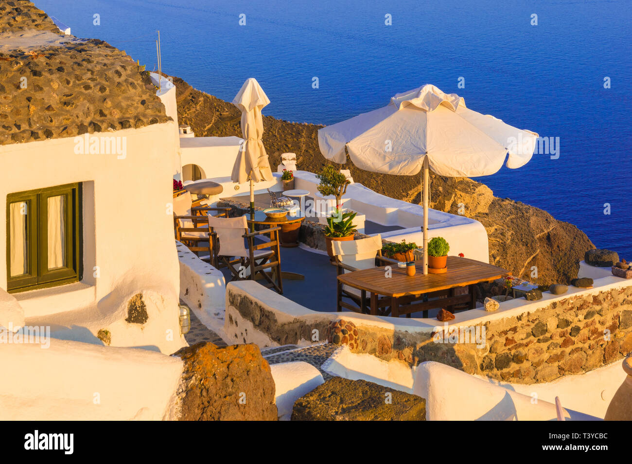 Santorini caldera view restaurant table and chairs hi-res stock ...