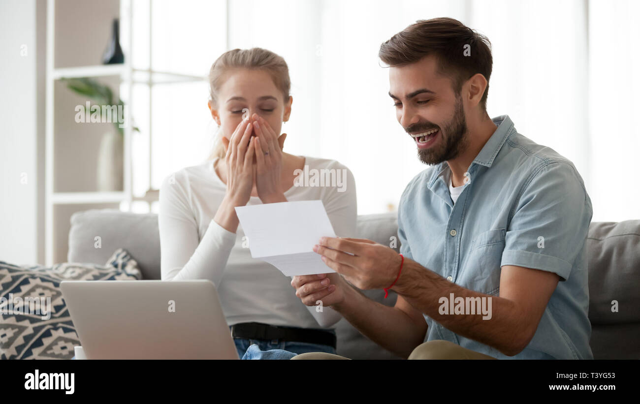 Happy excited young couple receiving unexpected good news Stock Photo ...