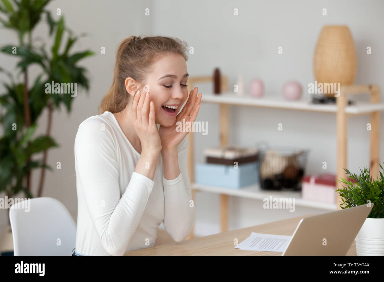 Excited woman looking at laptop screen, celebrating good news receiving ...