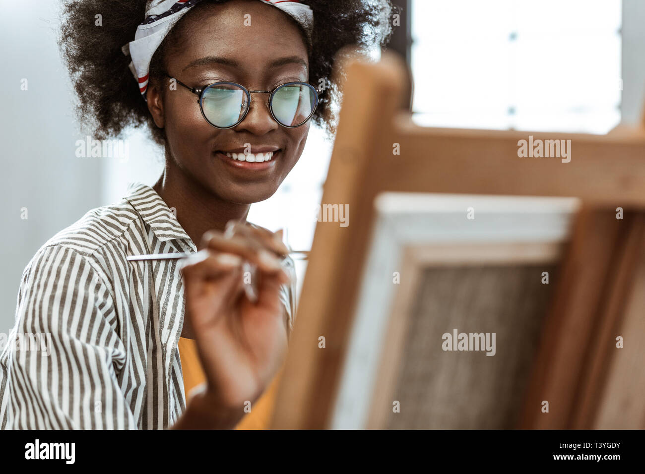 Inspired and excited. Close up of beautiful African-American artist ...