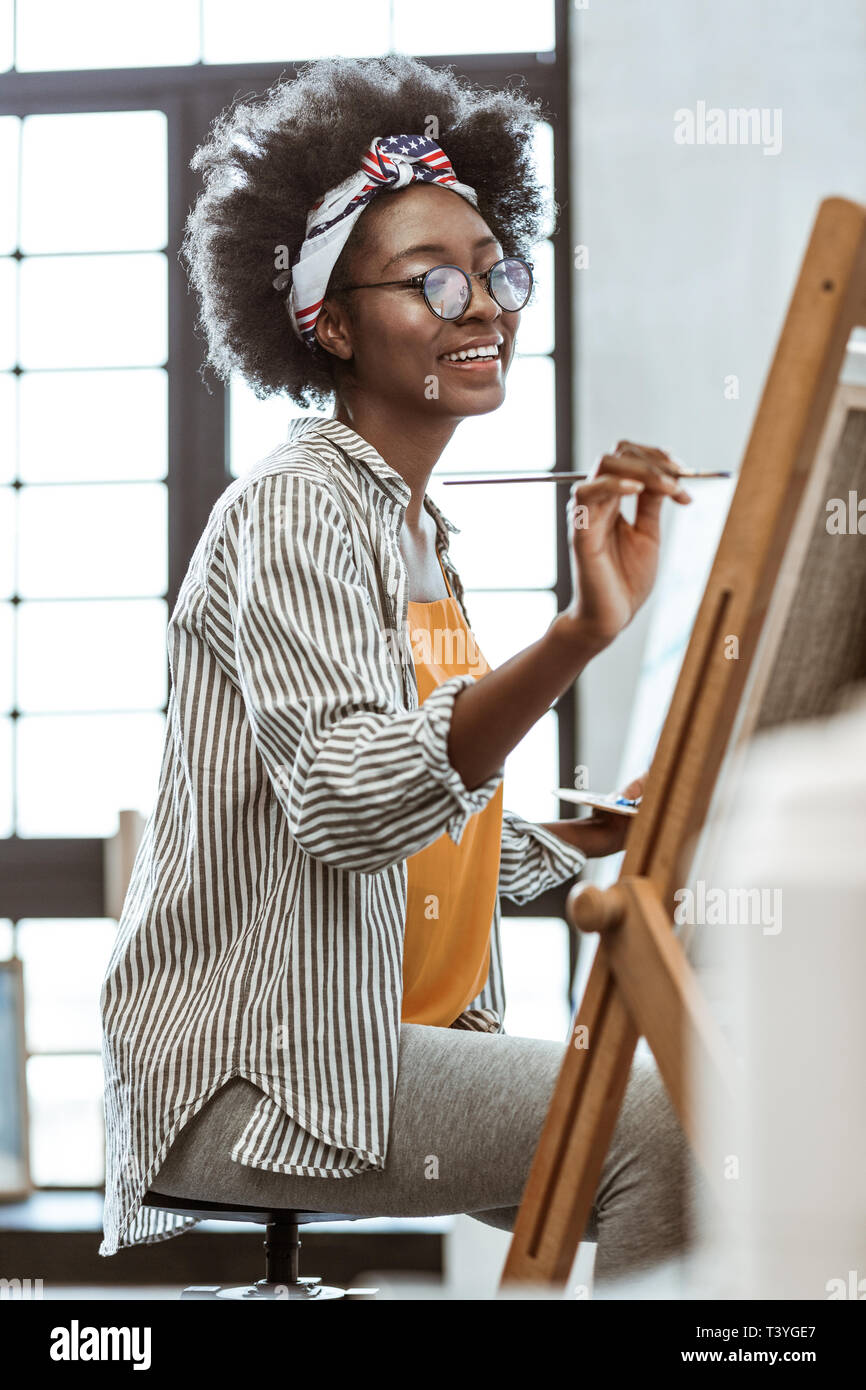 Talented artist. Creative talented African-American artist sitting in ...