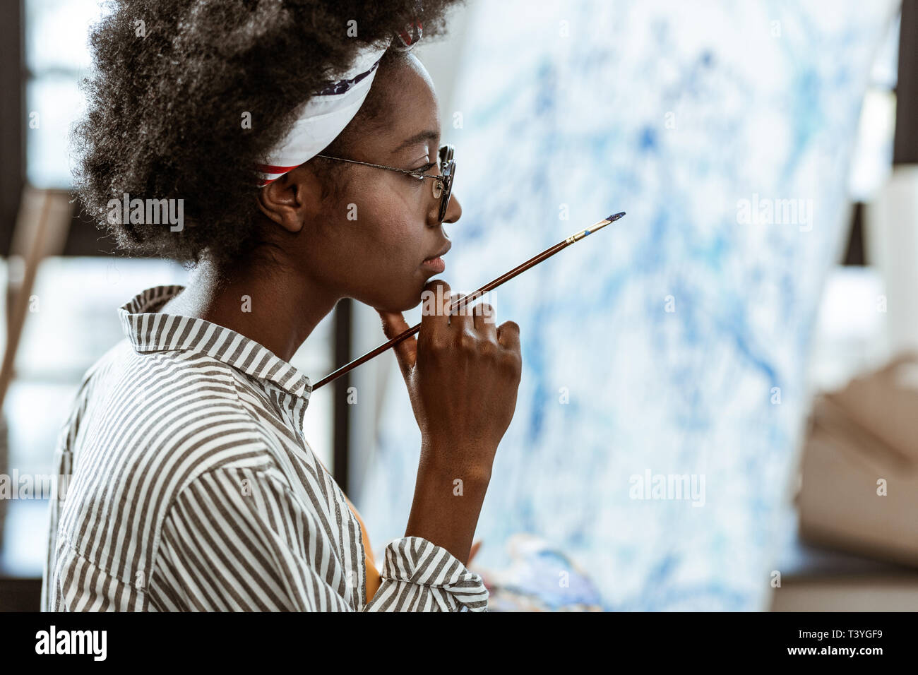 Thoughtful artist. African-American artist feeling thoughtful while ...