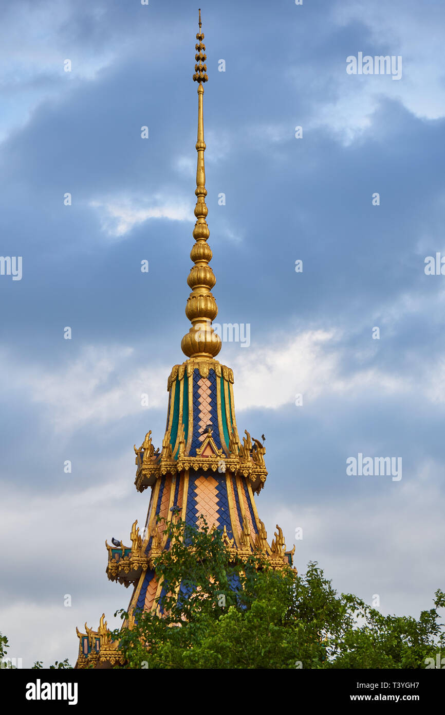 Green and gold spire at the top of Phnom Mondap in the Silver Pagoda ...
