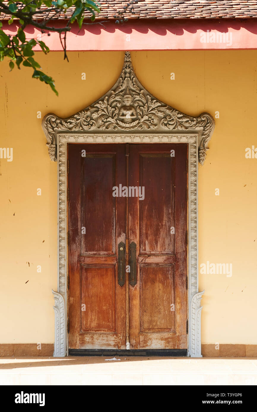Ornamented door along a hallway veranda inside the Royal Palace grounds ...